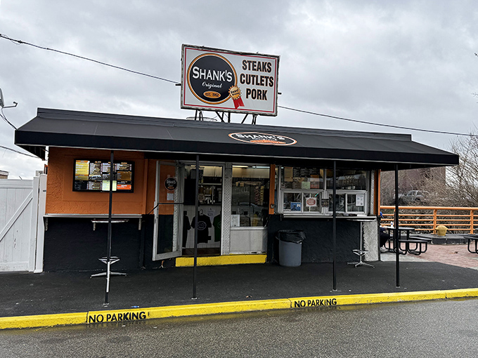 The unassuming orange and black exterior of Shank's Original stands like a sandwich sentinel on Pier 40, promising Philadelphia glory between two slices of bread.