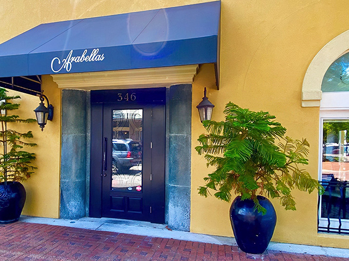 The golden fa&ccedil;ade and royal blue awning of Arabellas isn't just a restaurant entrance&mdash;it's a portal to Italy hiding in plain sight on Winter Haven's brick-lined streets.