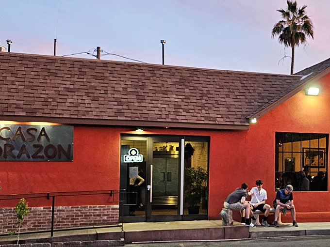 The coral-colored exterior of Casa Corazon glows like a sunset against the Phoenix sky, beckoning hungry travelers with its vibrant promise of authentic flavors.