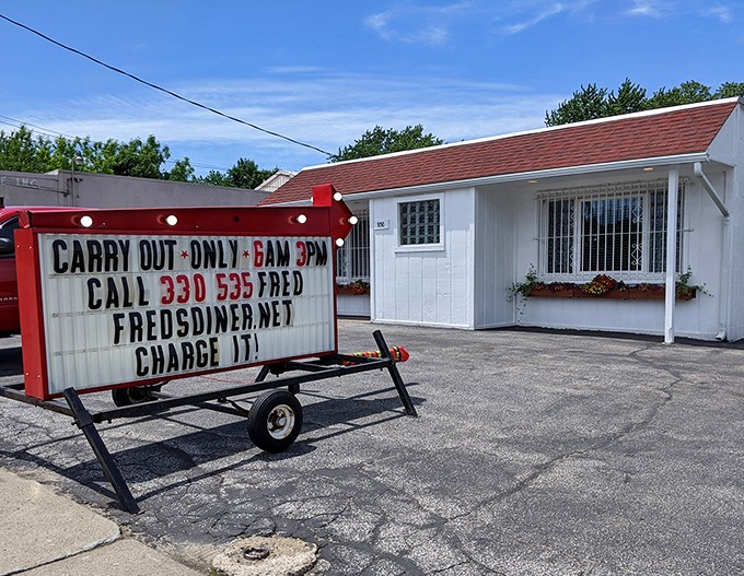 The unassuming white exterior of Fred's Diner proves once again that culinary treasures often hide in plain sight. Those flower boxes are your first clue to the warmth waiting inside.