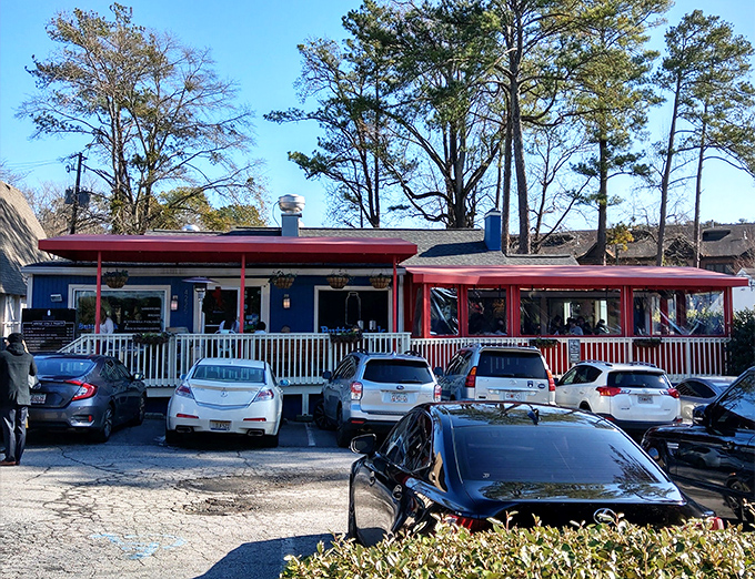The blue cottage with its striking red awnings stands like a breakfast beacon in Buckhead, promising morning delights worth any wait.