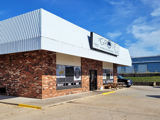 The unassuming brick facade of The Grove Family Restaurant hides culinary treasures within. That "FREE PIE" sign isn't just decoration&mdash;it's a promise of sweet things to come.
