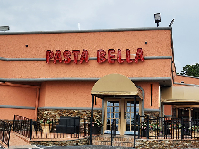 The coral-colored exterior with bold red signage promises Italian comfort without pretension. Like a beacon of carb-laden joy in suburban Marietta.