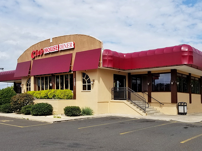 The Club House Diner's iconic red awnings and cream exterior stand as a beacon of comfort food promise in Bensalem. Like finding an old friend in a sea of chain restaurants.
