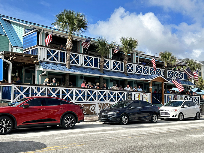 The seafoam-green charm of Flagler Tavern beckons from Flagler Avenue, its wraparound porches promising cold drinks and ocean breezes just steps from the Atlantic.