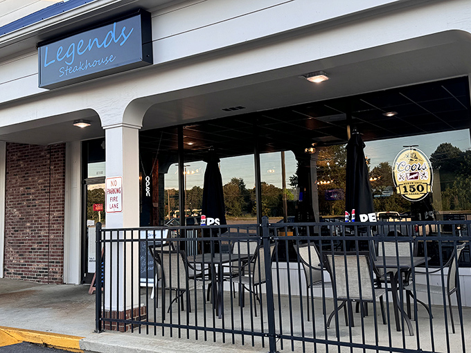 The blue sign beckons like a lighthouse for hungry souls. Legends Steakhouse's modest exterior hides culinary treasures within. 