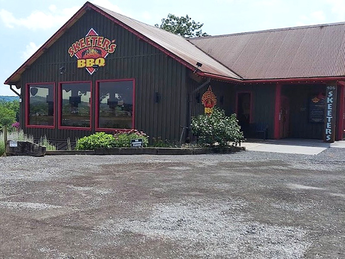 The rustic green exterior with its bold red trim isn't just country charm—it's a smoke signal to BBQ lovers that something magical awaits inside.