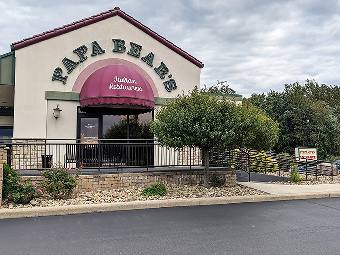 The welcoming facade of Papa Bear's Italian Restaurant in North Canton beckons with its distinctive burgundy awning and stone accents&mdash;like a warm Italian hug in building form.