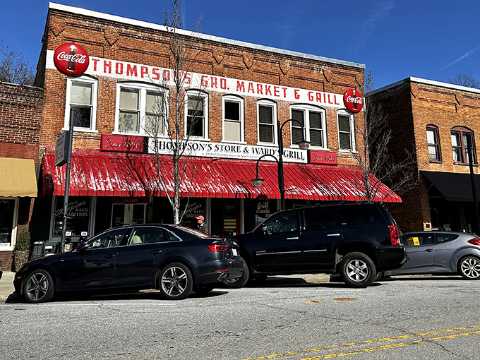 The iconic red awning of Thompson's Store & Ward's Grill beckons like a culinary lighthouse on Saluda's Main Street. Small-town charm, big-time flavor awaits. 