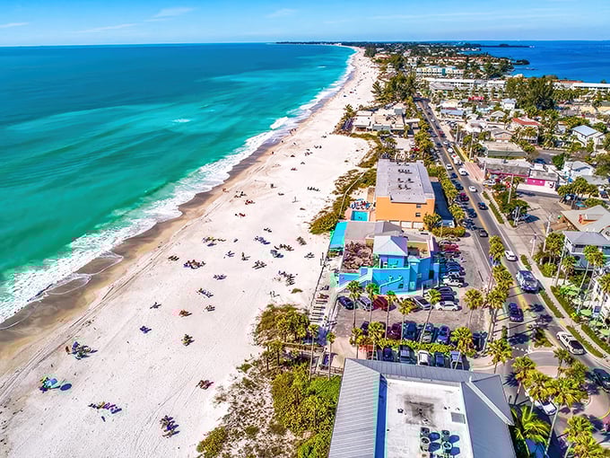 Where turquoise waters meet powdery white sand, Anna Maria Island stretches like nature's perfect welcome mat. This aerial view shows why locals guard their secret paradise fiercely.
