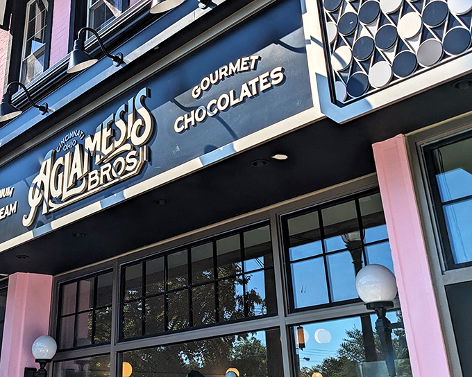 The iconic blue Aglamesis Bros storefront beckons like a portal to a sweeter era, promising ice cream dreams and chocolate fantasies behind those welcoming doors.