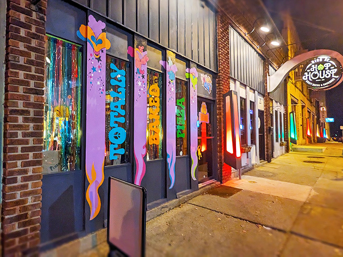The psychedelic storefront of Totally Baked Pizza glows like a neon oasis on Akron's High Street, beckoning hungry travelers with its groovy vibes.