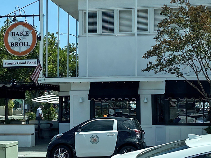 The iconic orange sign promises "Simply Good Food" – a refreshing understatement that's like calling the Grand Canyon "a pretty nice hole."