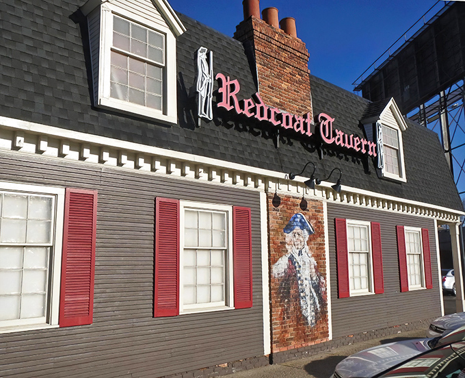 The colonial-style exterior of Redcoat Tavern stands proudly on Woodward Avenue, its red shutters and iconic sign promising comfort food magic within.