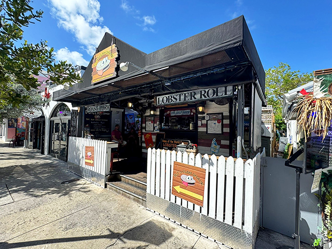 The unassuming facade of DJ's Clam Shack beckons seafood lovers with its charming white picket fence and promise of lobster roll nirvana.