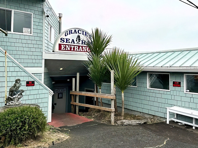The seafoam green exterior of Gracie's Sea Hag stands like a coastal sentinel, promising seafood treasures within its unassuming walls.