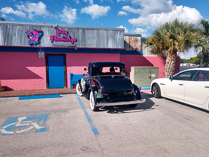 The pink exterior of The Lazy Flamingo isn't just a building&mdash;it's a promise of Florida fun that delivers every time. Classic cars and palm trees complete the postcard-perfect scene.