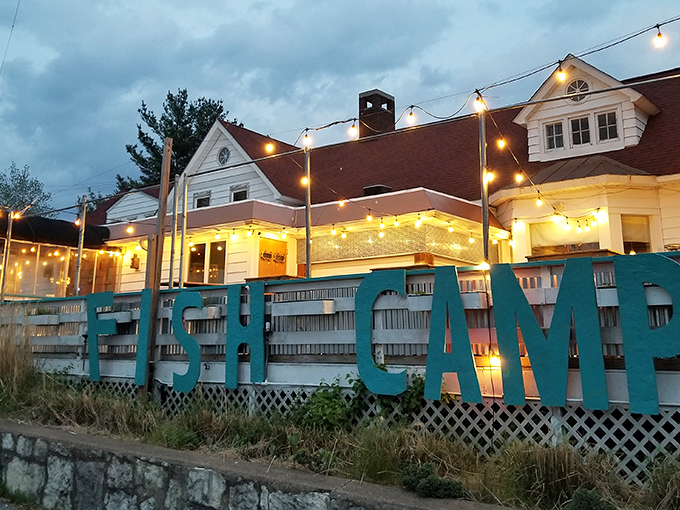 The bold white "FISH CAMP" sign against the white building is like a lighthouse for hungry souls&mdash;guiding seafood pilgrims to their delicious destination.