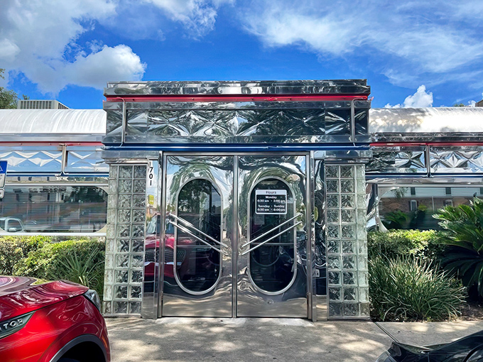 Chrome and nostalgia shine at Scenic 90 Cafe's exterior, a time capsule of Americana gleaming in the Florida sunshine like a vintage postcard come to life.