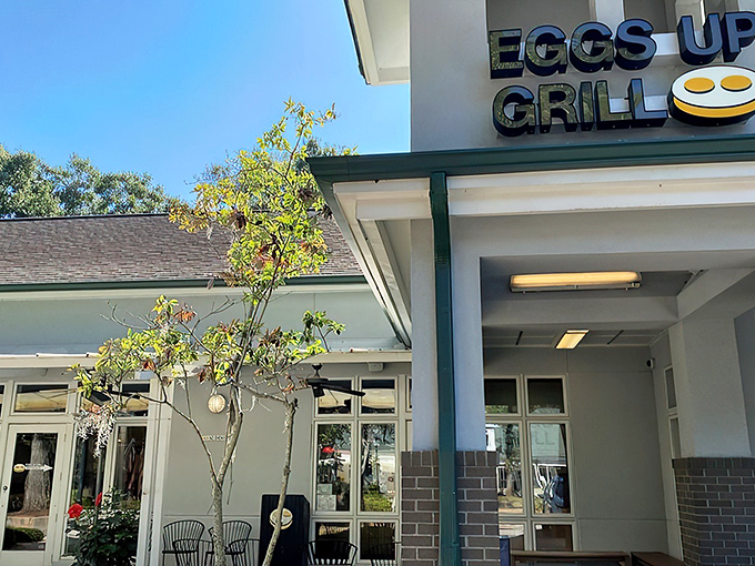 The inviting exterior of Eggs Up Grill beckons with its cheerful sign and welcoming porch &ndash; like a breakfast lighthouse guiding hungry souls to shore.