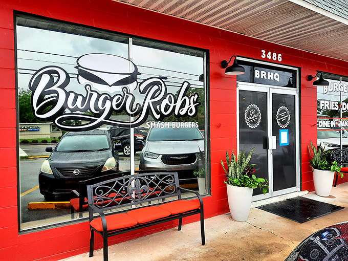 The bright red exterior of BurgerRobs stands like a beacon of burger hope in Titusville, promising simple pleasures: burgers, fries, and dogs done right.