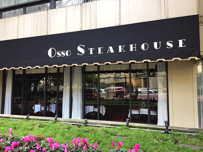 Elegance announces itself quietly on Nob Hill, where Osso Steakhouse's classic black awning and vibrant flower boxes promise sophisticated delights within.
