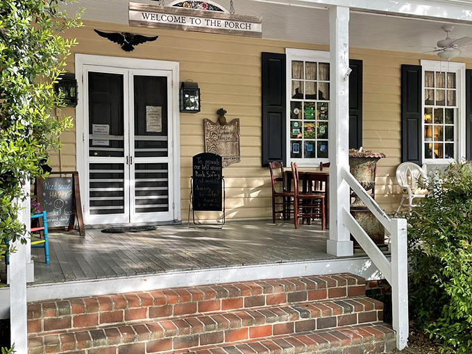 The porch says "Welcome" and means it. That bright blue rocking chair isn't just furniture&mdash;it's an invitation to slow down and savor what's coming. 
