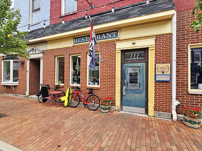The brick facade of Liberty Gathering Place welcomes you like an old friend, complete with charming blue door and red bicycle parked outside.