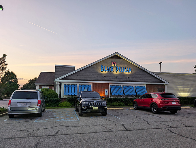 The Black Pelican's colorful sign welcomes hungry travelers with coastal charm. Those weathered shingles have stories to tell.