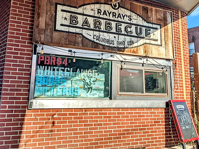 The wooden sign says "barbecue" but what it really means is "prepare for a religious experience." Simple brick exterior, extraordinary flavors within.