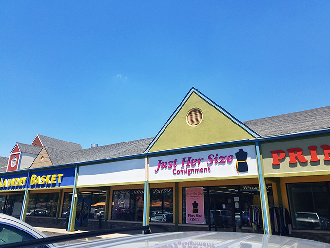 The pink neon sign of Just Her Size Consignment glows like a beacon for bargain hunters in Fairfield, promising fashion treasures waiting to be discovered.