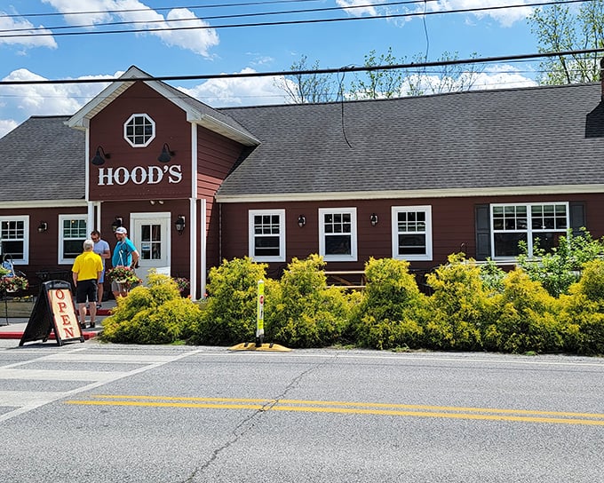 Hood's BBQ stands proud in Kennett Square, its barn-red exterior and welcoming entrance promising smoky delights within. The landscaping adds a touch of charm that says "come on in, hungry traveler."
