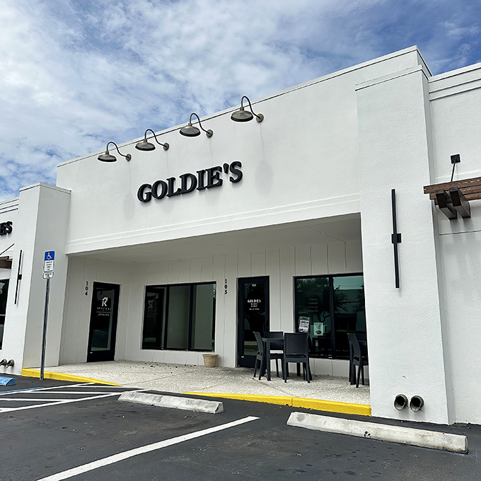 Goldie's unassuming white exterior might fool you, but those vintage gooseneck lights are practically winking, "Trust me, the breakfast magic happens inside."