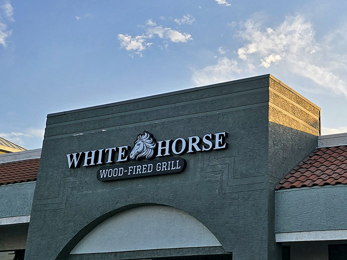 The unassuming exterior of White Horse Wood-Fired Grill proves the old adage: never judge a burger joint by its stucco facade.