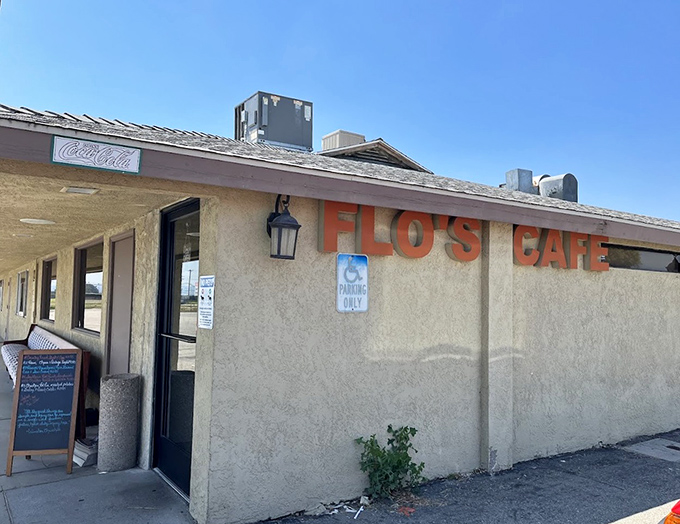 The unassuming exterior of Flo's Airport Cafe stands like a time capsule at Chino Airport, promising comfort food that's been fueling pilots and locals for generations.