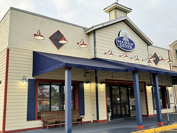 The welcoming facade of Broadway Diner in Bartow beckons with its classic blue awning and warm lighting&mdash;like a culinary lighthouse for hungry travelers.
