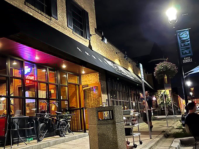 The brick facade of River Street Tavern beckons like an old friend, that distinctive orange door promising comfort and culinary adventures within.