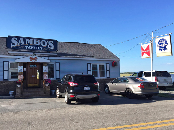The unassuming blue exterior of Sambo's Tavern stands like a culinary lighthouse, beckoning seafood pilgrims to the shores of Leipsic with quiet confidence.