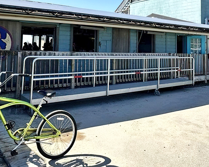 The weathered blue exterior and bright yellow bicycle perfectly capture Southport's laid-back coastal charm. Seafood paradise awaits beyond that unassuming ramp.