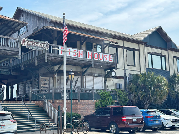 The weathered wooden exterior of The Fish House stands like a sentry guarding Pensacola's seafood treasures, its red lettering a beacon to hungry travelers.