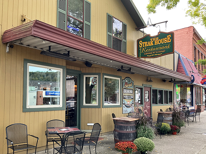The yellow clapboard exterior of The Steak House in Wellsboro beckons like a beacon of hope for hungry travelers, complete with charming sidewalk seating.