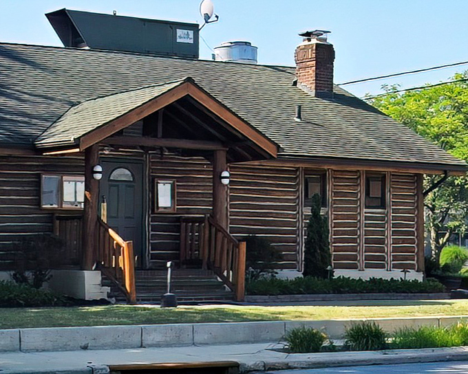 The log cabin exterior isn't just rustic charm&mdash;it's a promise of what awaits inside: warmth, comfort, and steaks that'll make you forget your name.