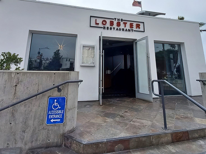 The pristine white exterior of The Lobster stands like a culinary lighthouse at the entrance to Santa Monica Pier, beckoning seafood lovers home.