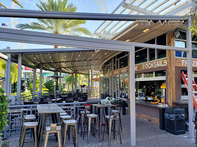 iCafe de Paris glows like a beacon next to Orlando's observation wheel, promising European charm with a side of Florida flair.