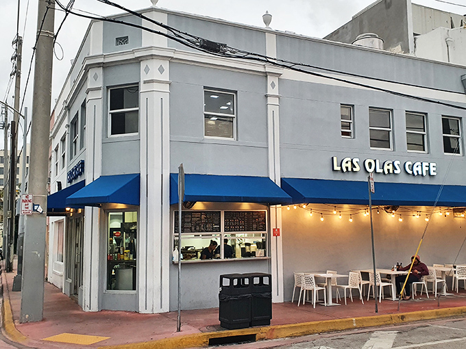 The unassuming white facade with blue awnings of Las Olas Cafe stands like a beacon of Cuban culinary authenticity in Miami Beach's glitzy landscape.