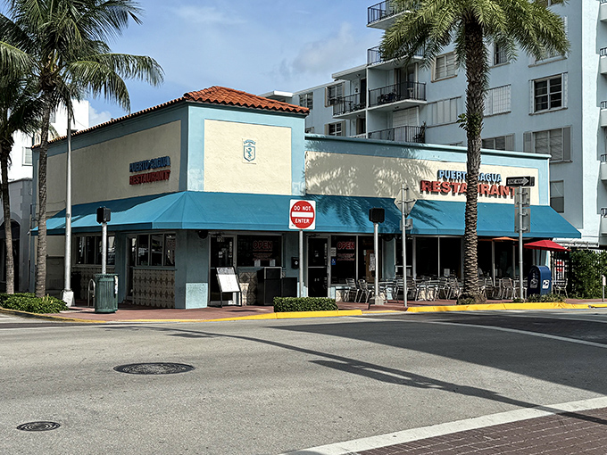The iconic blue exterior of Puerto Sagua stands like a culinary lighthouse on Collins Avenue, beckoning hungry travelers with promises of Cuban delights.