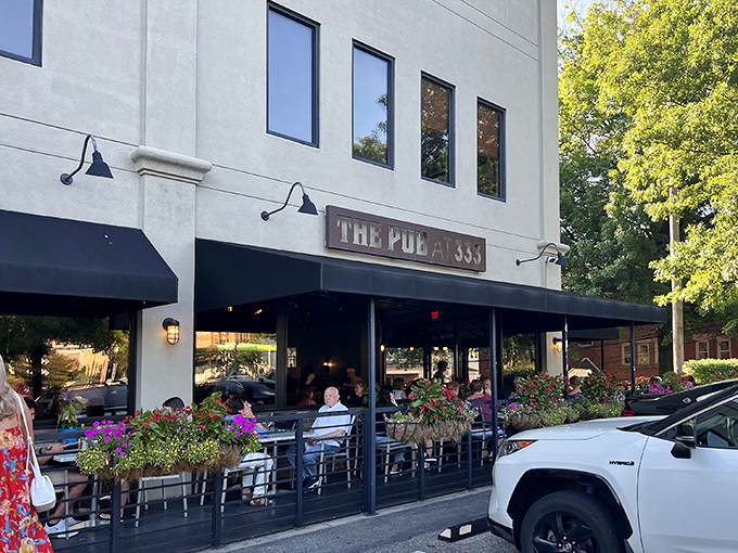 The welcoming facade of The Pub at 333 in Oakmont, with seasonal corn stalks and flowers creating that "come on in" vibe every neighborhood gem should have.