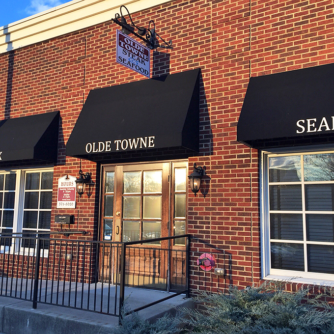 The unassuming brick exterior of Olde Towne Steak & Seafood might not stop traffic, but locals know those black awnings mark the entrance to flavor paradise.