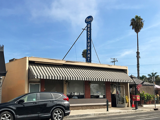 The iconic Pete's Breakfast House sign stands tall against the California sky, a beacon of breakfast hope for hungry travelers on East Main Street.