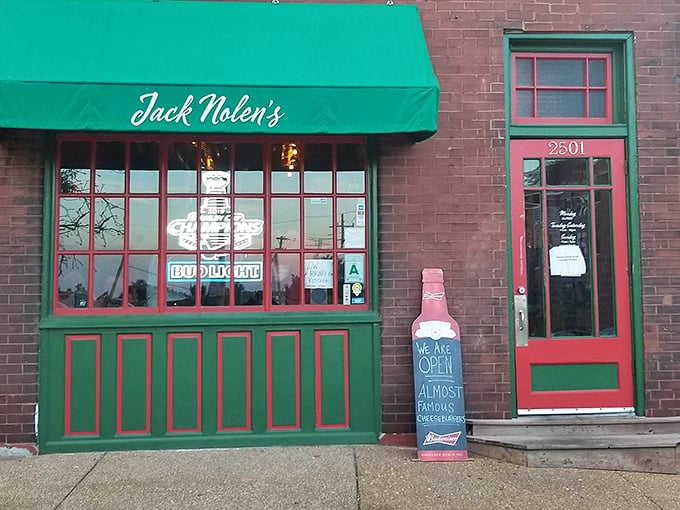 The unassuming exterior of Jack Nolen's, with its classic brick facade and green awning, proves that burger greatness often hides in plain sight.